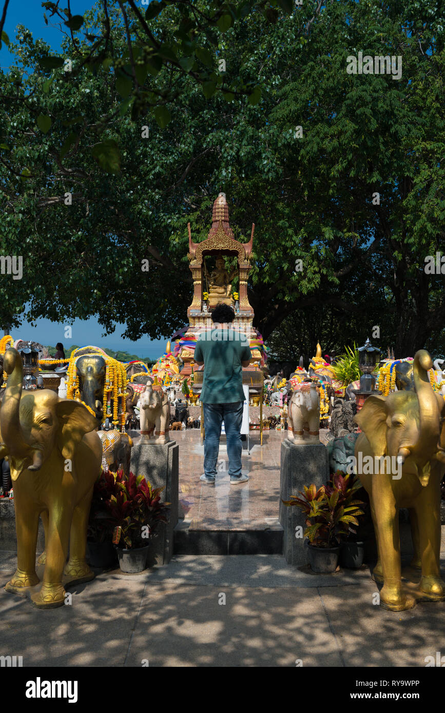 Young man praying in the shrine to elephants on Promthep cape, Phuket ...