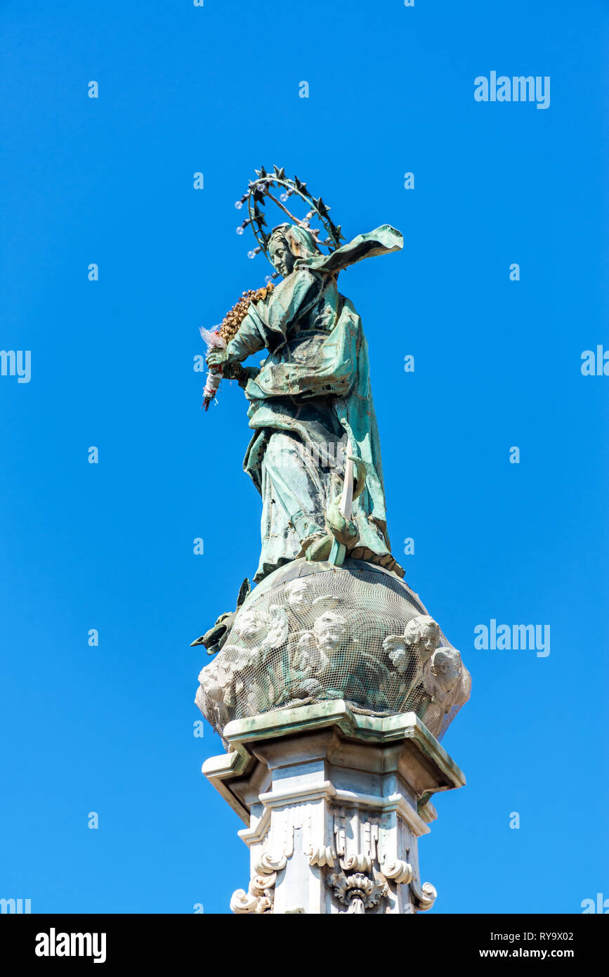 Virgin Mary statue on an obelisk in New Jesus Plaza in Naples, Italy ...
