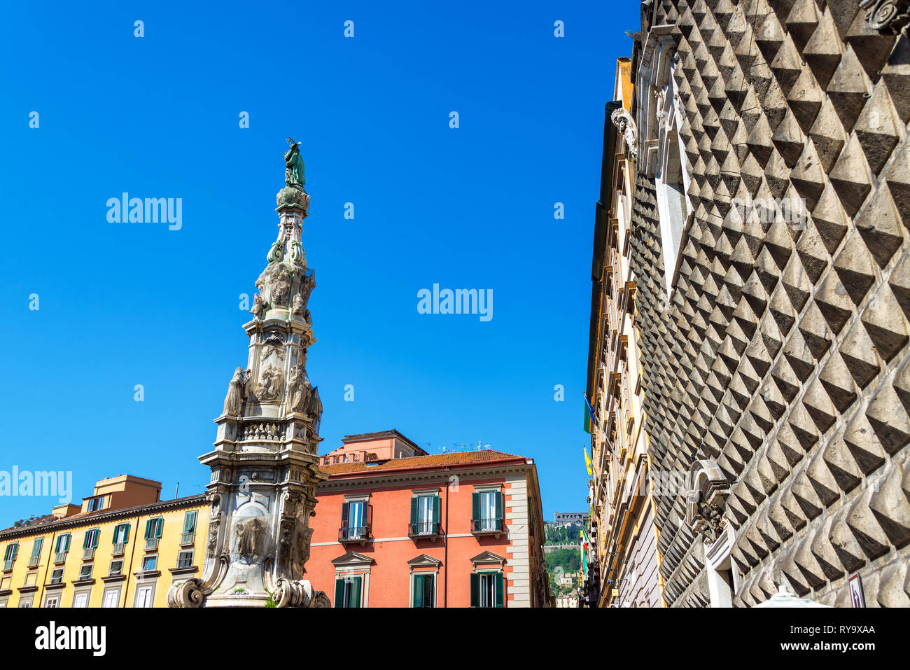 Colorful architecture and obelisk on New Jesus Plaza in Naples, Italy ...