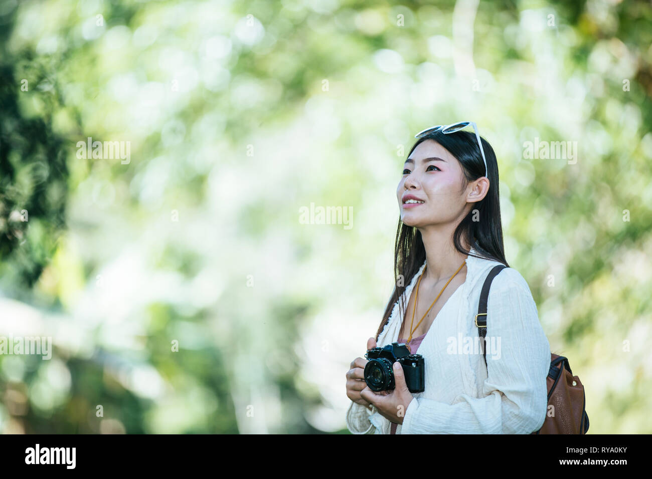 Female tourists who are taking photos of the atmosphere and smile ...