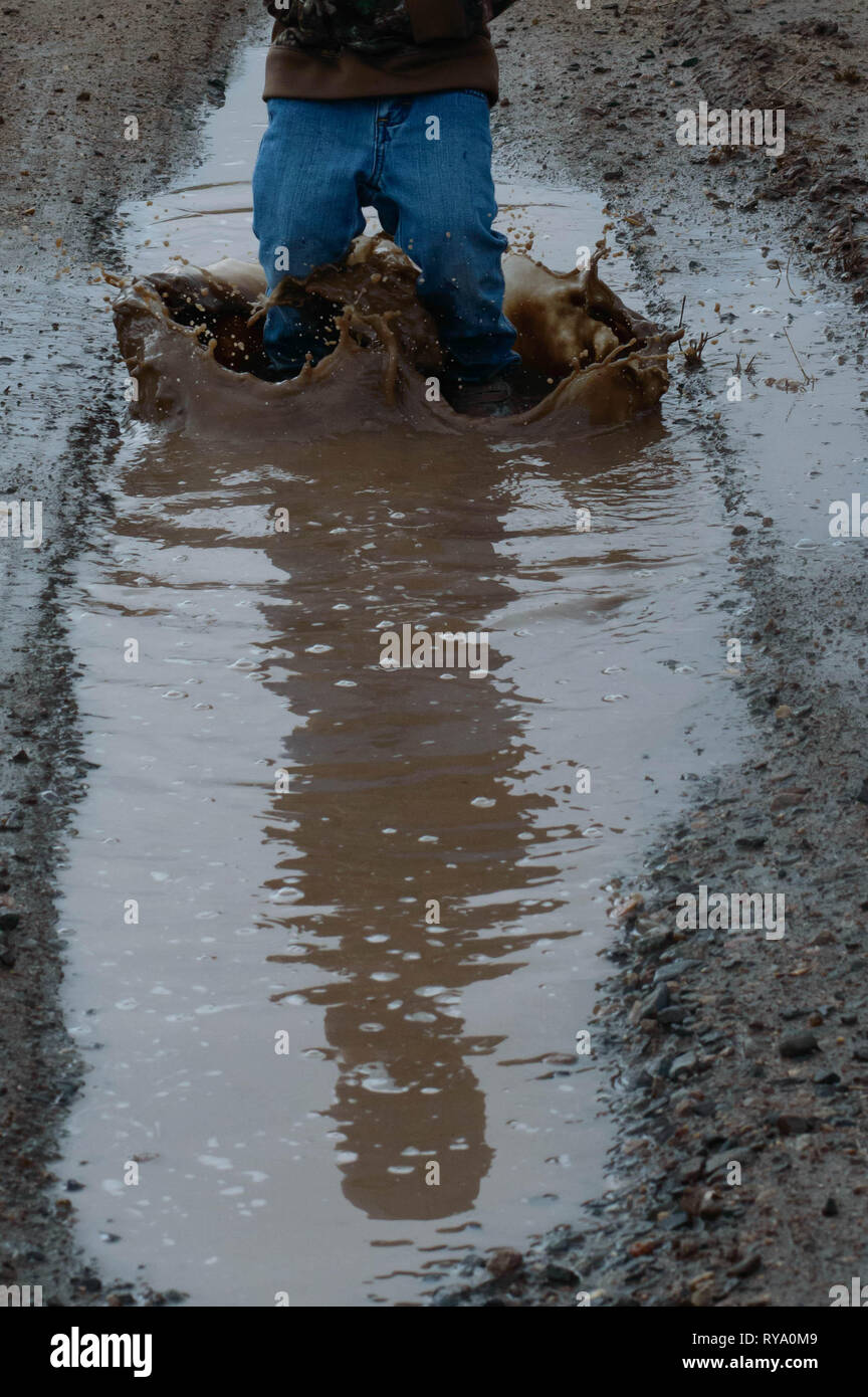 Kids jumping puddle hi-res stock photography and images - Alamy