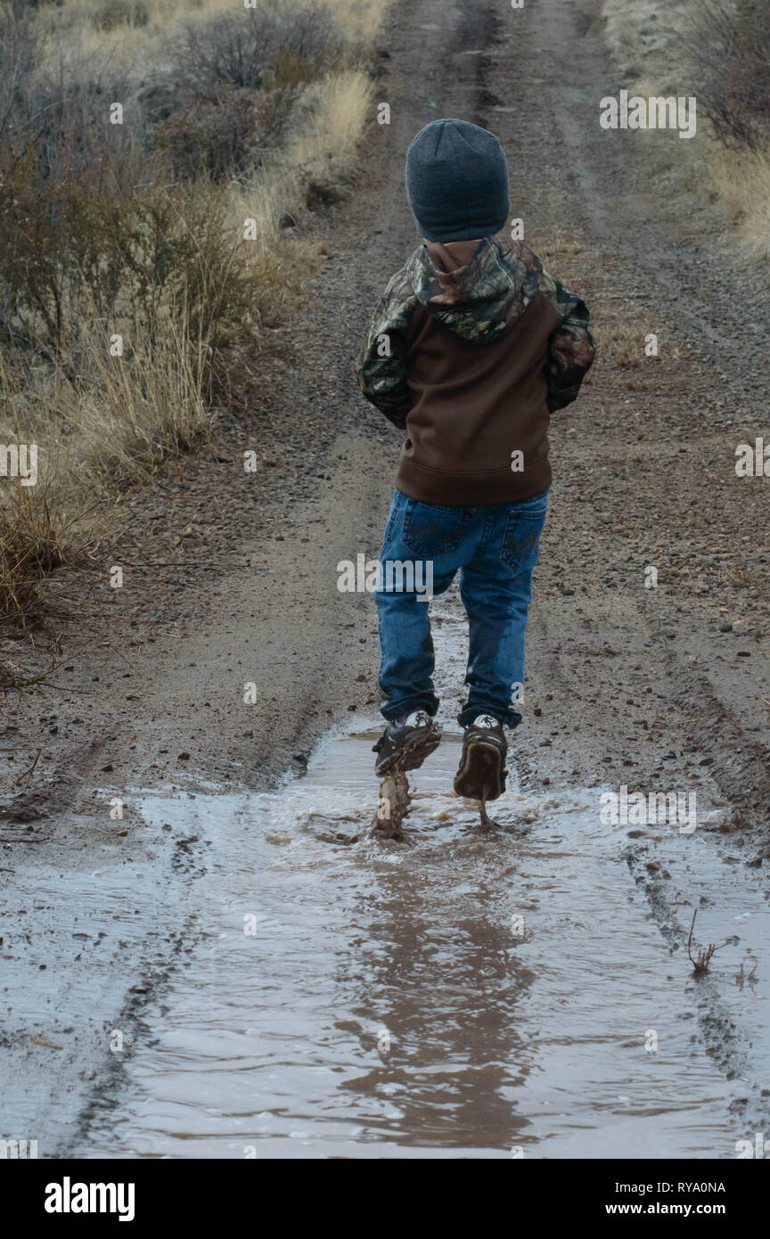 Kids jumping puddle hi-res stock photography and images - Alamy