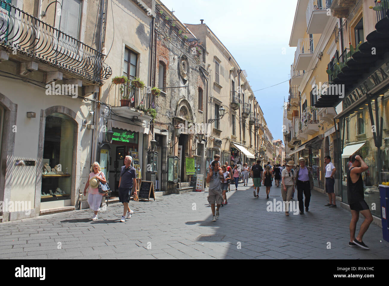 Taormina street with shoppers and tourists in the hilltop town on the ...