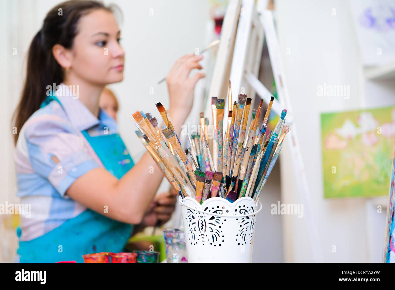 beautiful young girls draws a picture paints on art lesson Stock Photo ...