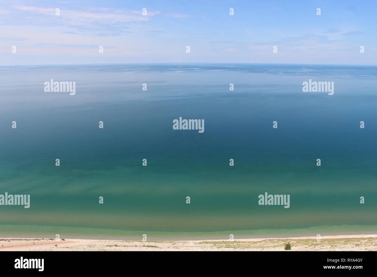 On top of a very tall sand dune, looking out at the white sand fade ...