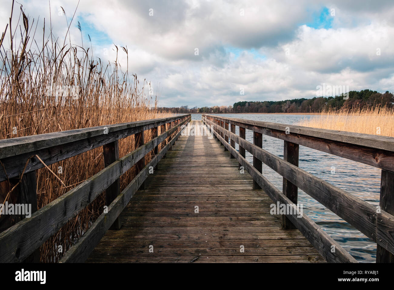 wooden pier at waterside - straight wood dock walkway at lake Stock ...
