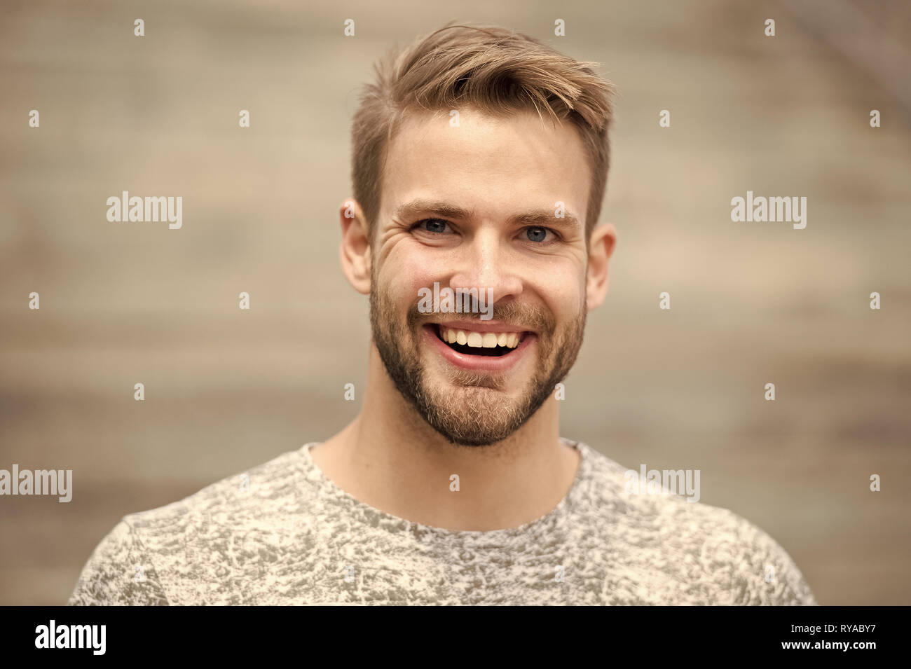 Man with perfect brilliant smile unshaven face defocused background ...