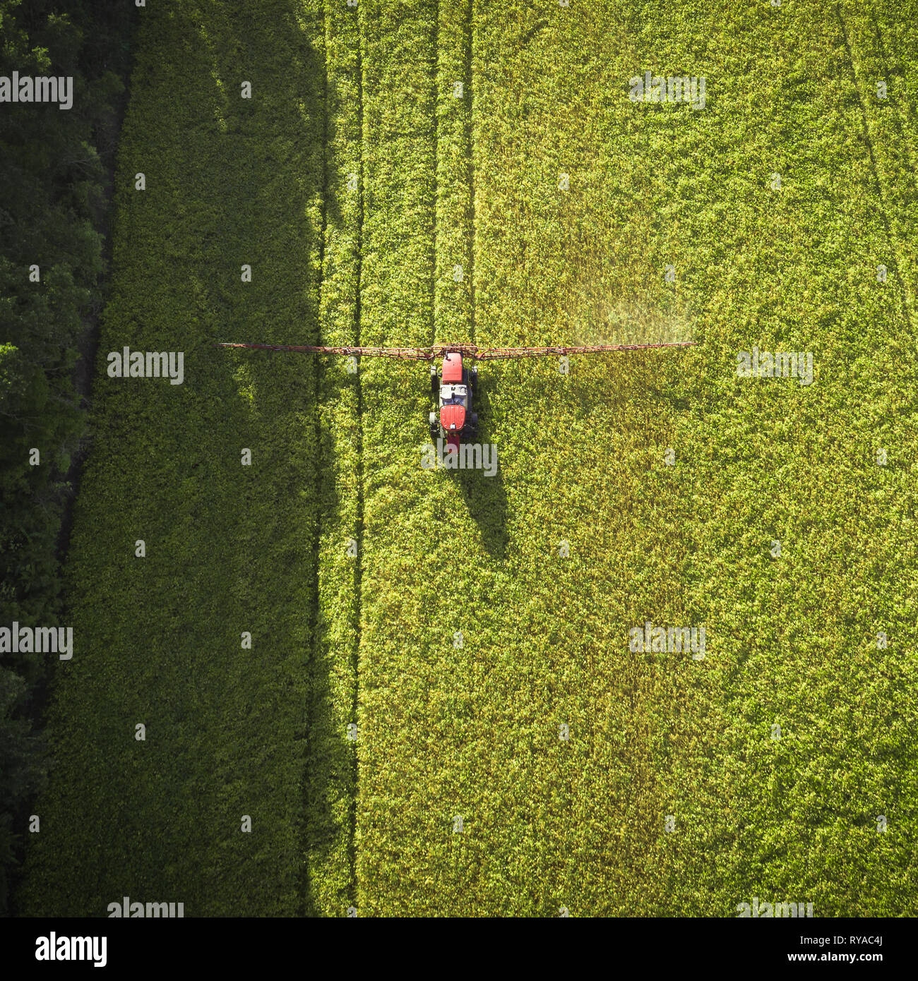 Agricultural machinery in the field. Tractor with a sprayer. Aerial ...