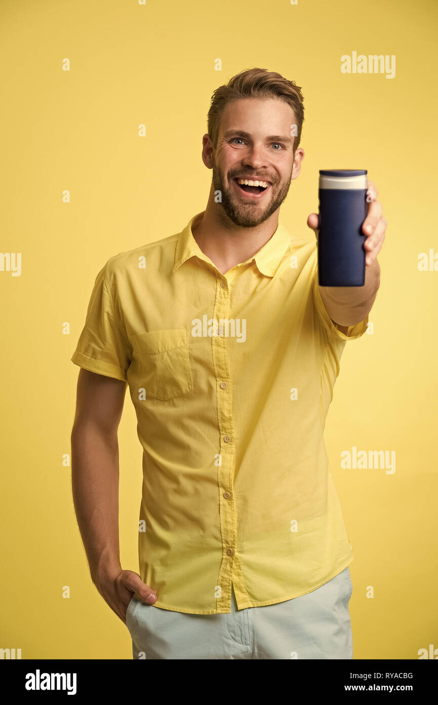 Man show his favorite shower gel or lotion for body. Guy satisfied with shower gel. Man bearded ...