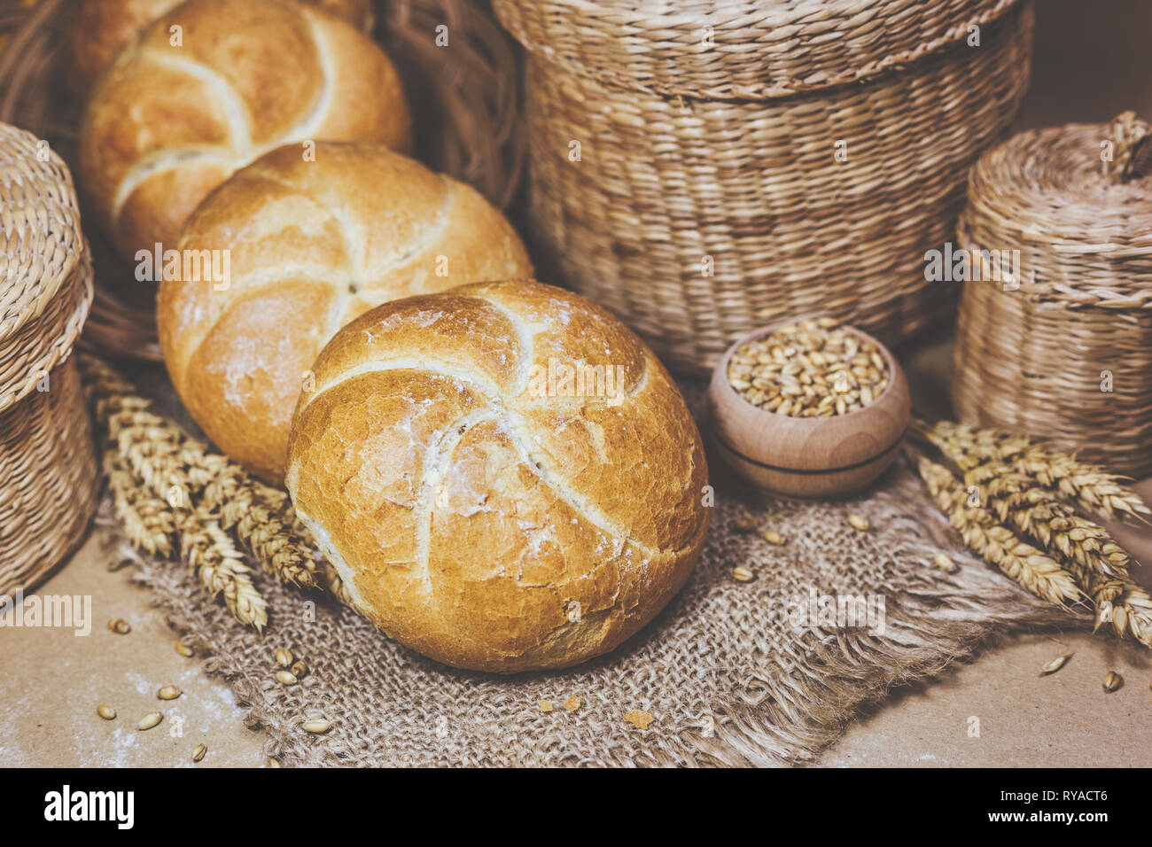 Close-up view of freshly baked bread on a rustic background with wheat ...