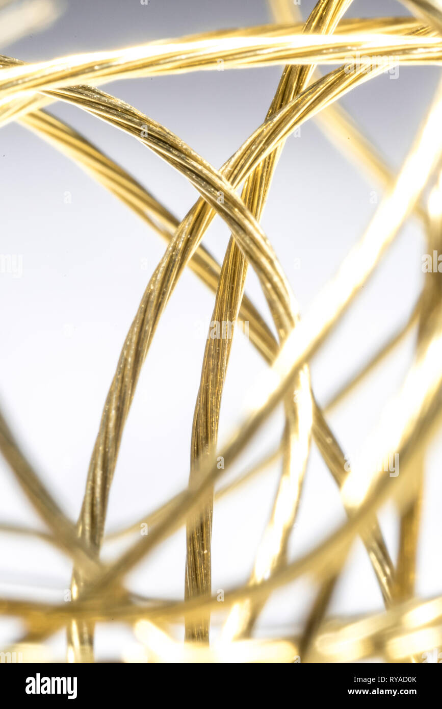Golden wires isolated on bright background Stock Photo - Alamy