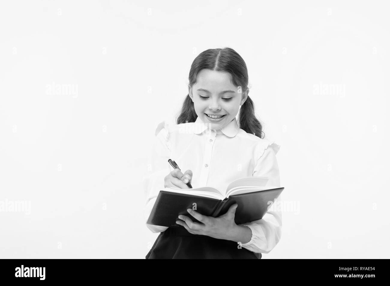 Making notes. Child school uniform kid doing homework. Child girl ...