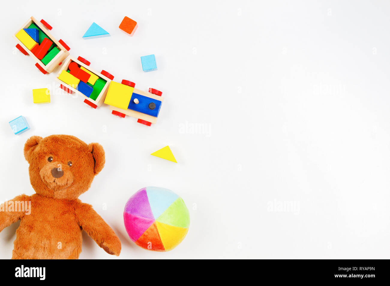 Baby kids toys background. Teddy bear, wooden train, colorful bricks on ...