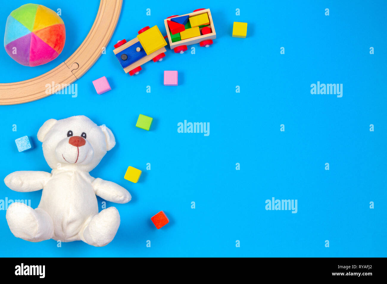 Kids toys background with teddy bear, wooden train and colorful blocks ...