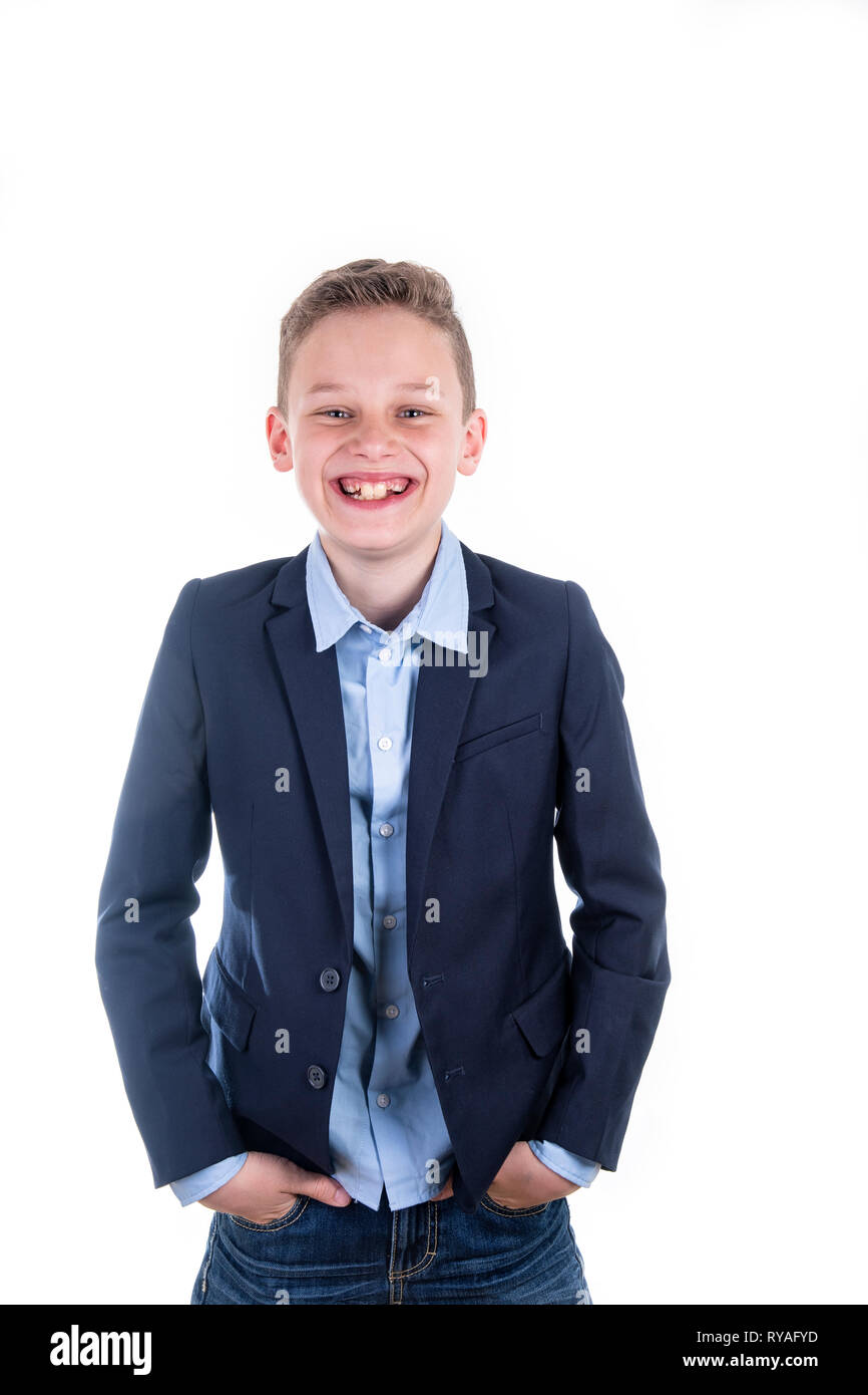 Boy in blue shirt and blue jacket laughs frontally into the camera ...