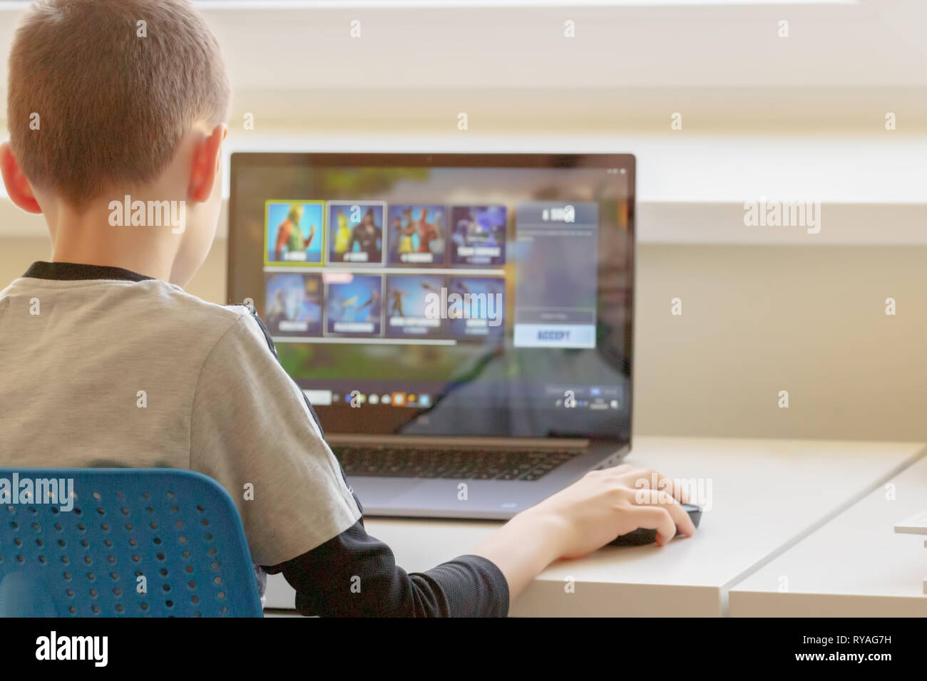 Boy playing Fortnite game. Fortnite is online video game developed by ...