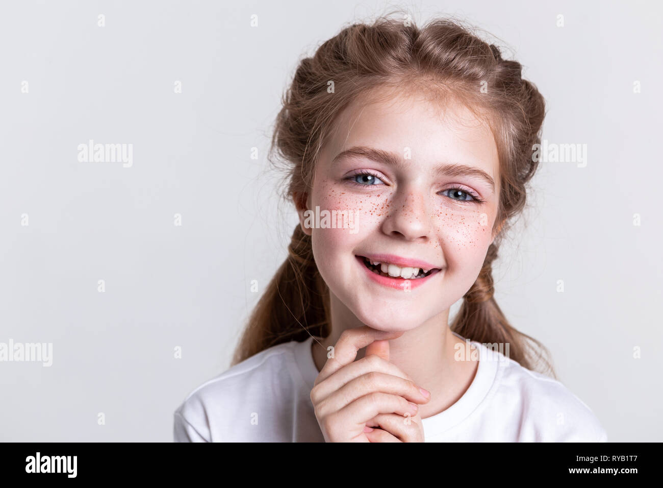 Contented little pretty kid showing her teeth in wide smile Stock Photo ...