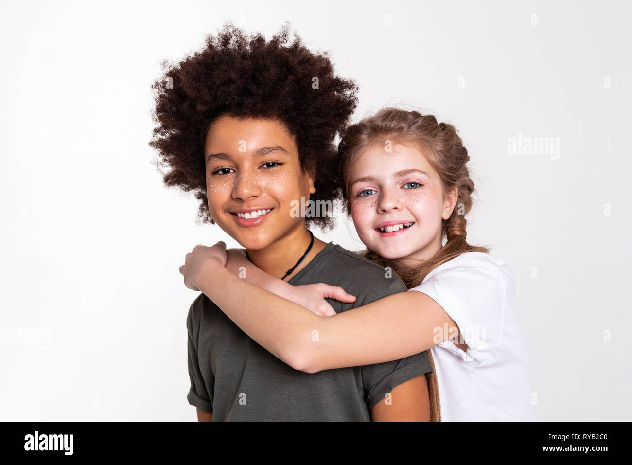 Contented good-looking kids spending time together in studio Stock ...