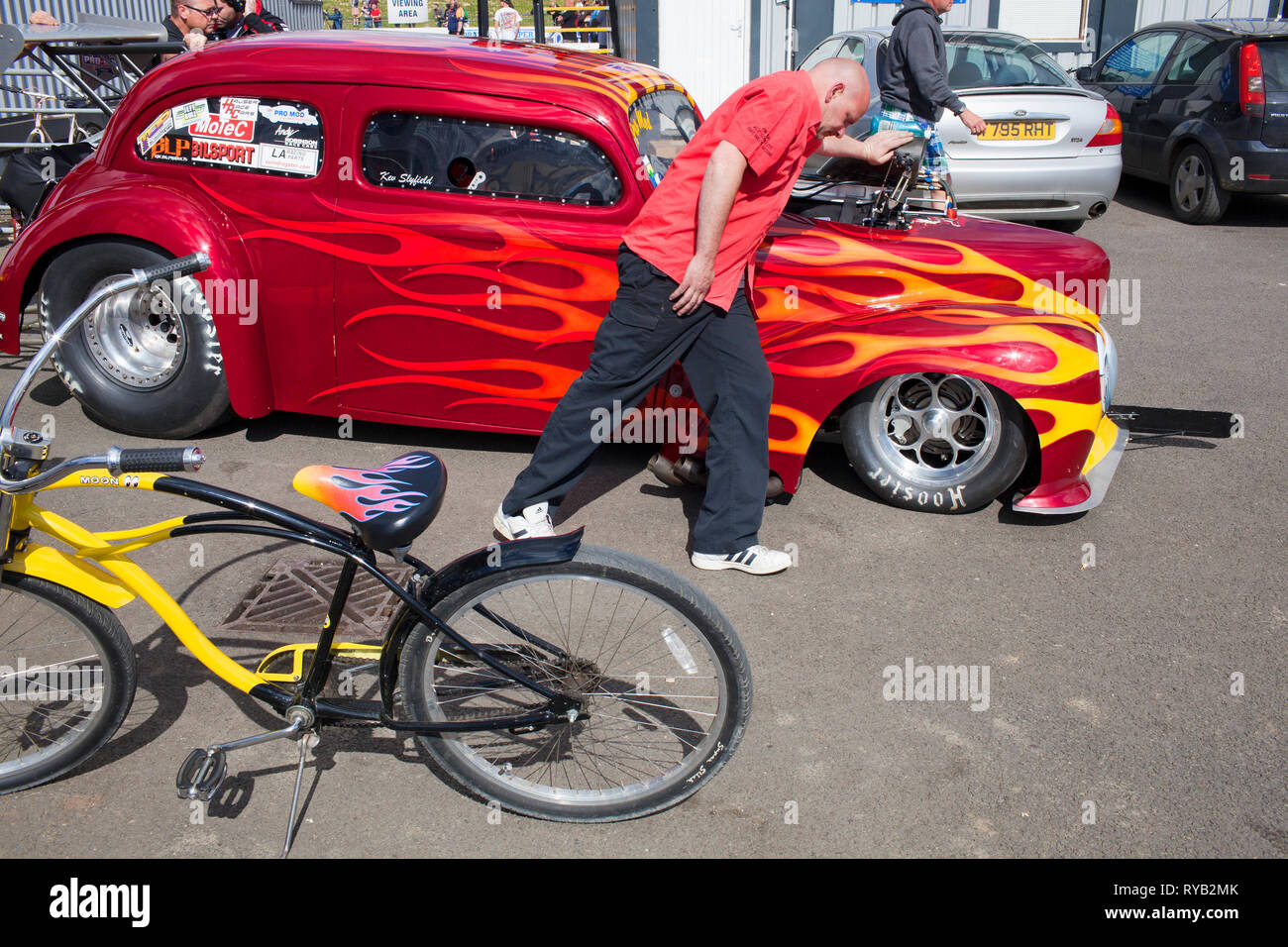 A fire themed classic car and bycycle Stock Photo - Alamy