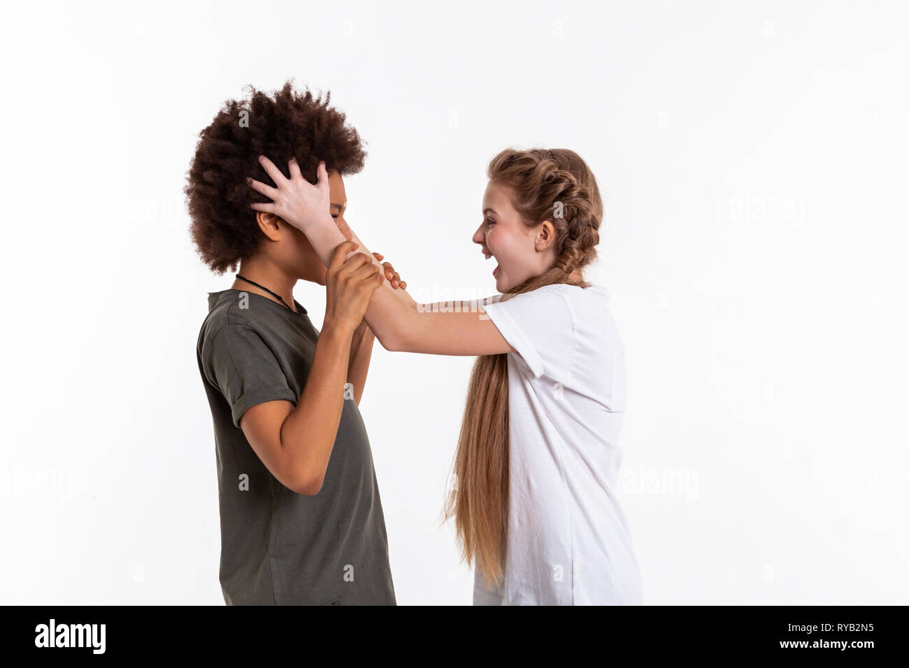 Mad long-haired blonde girl yelling on her confused friend Stock Photo ...