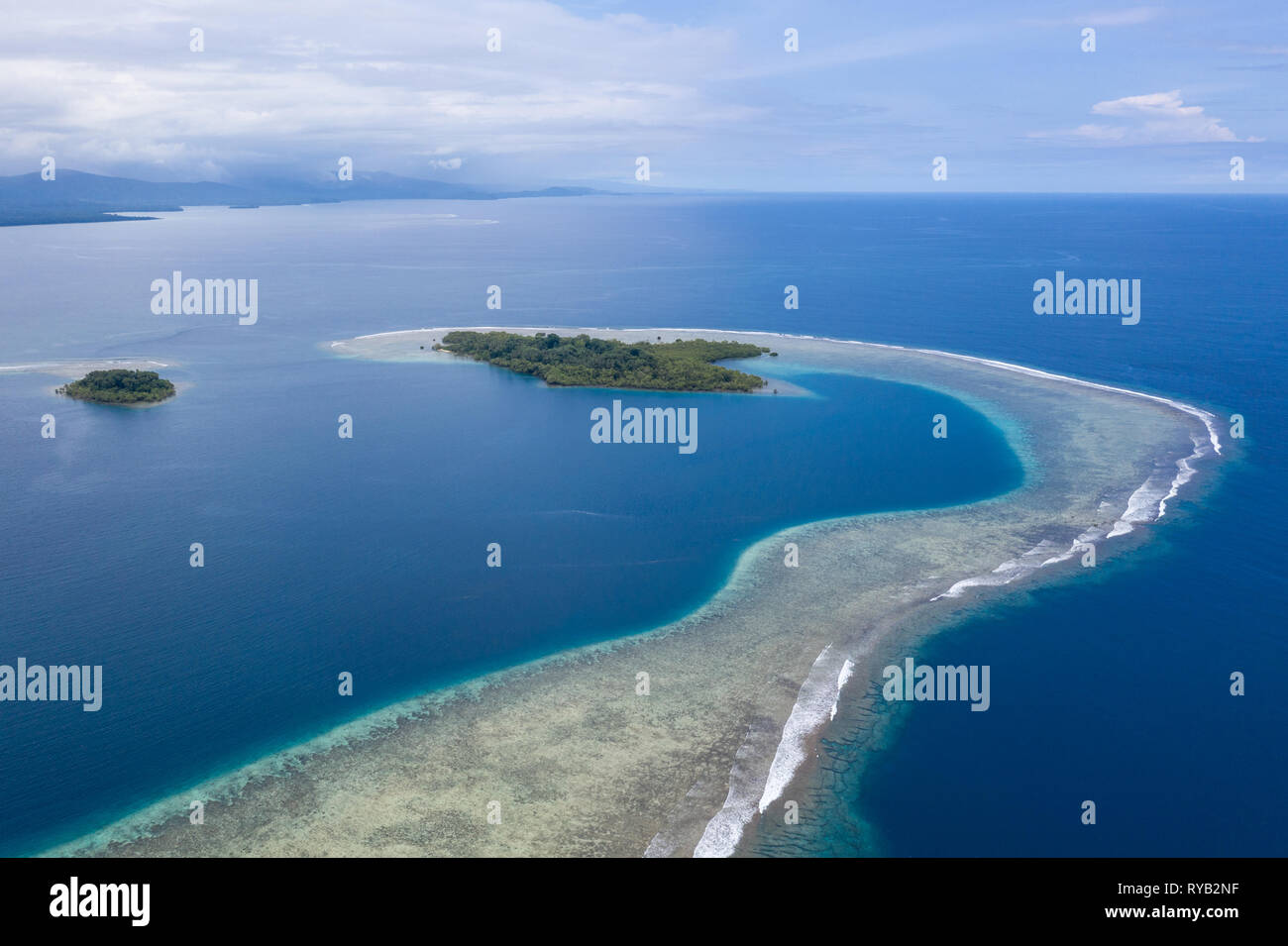 A gorgeous, tropical island is surrounded by reef in Papua New Guinea ...