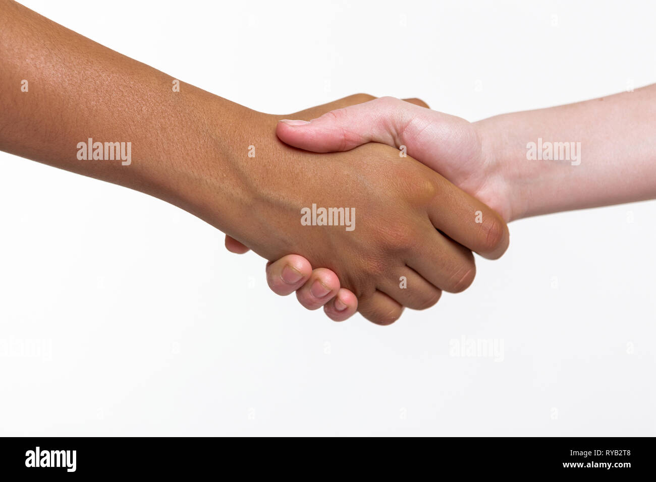 Pale and bronzed childish hands connecting in positive gesture Stock ...