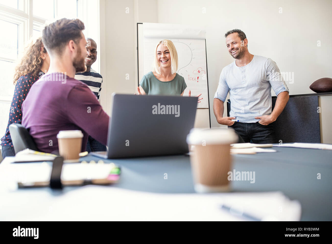 Diverse group of young designers talking together in an office after a ...