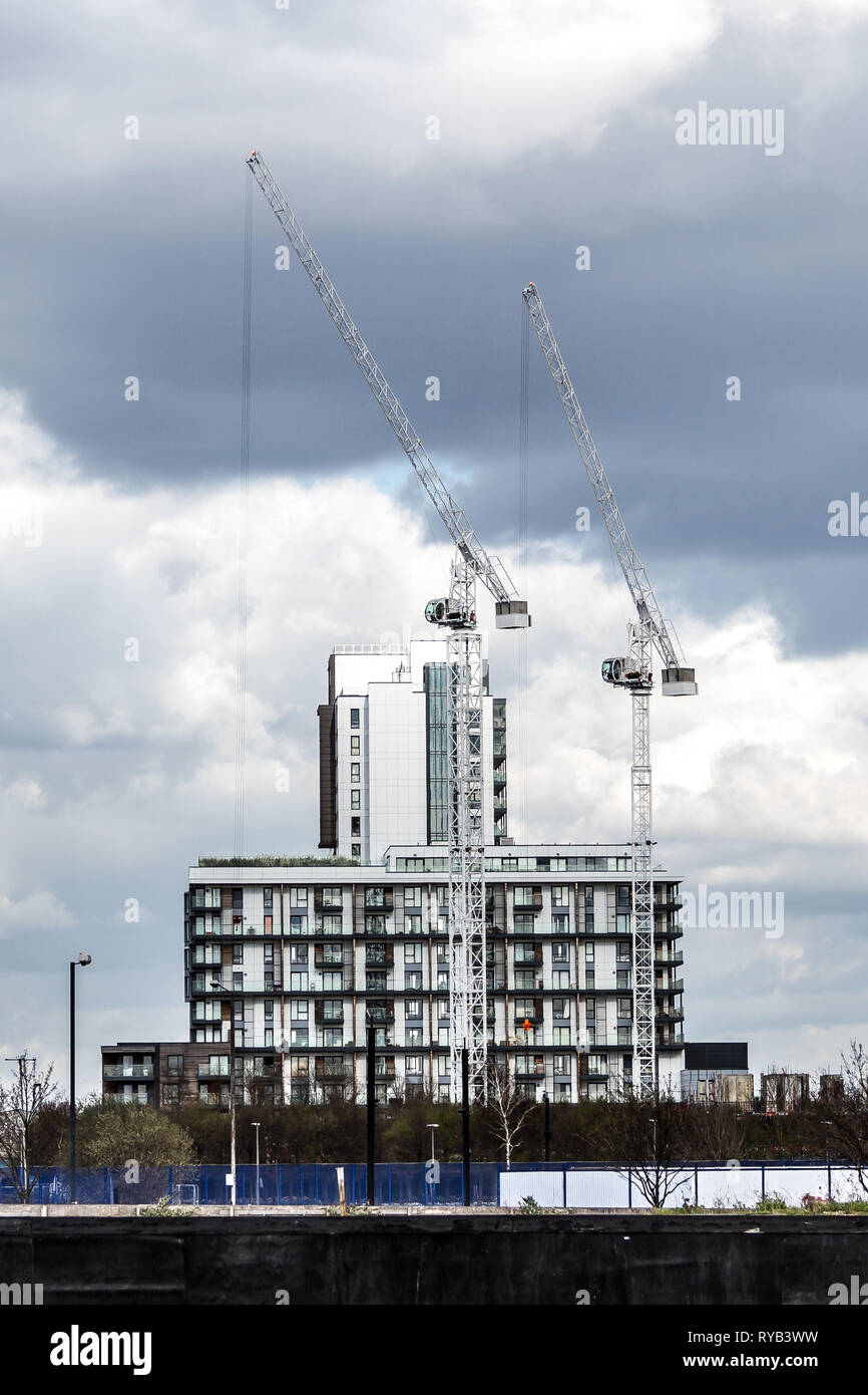 London building with construction cranes on a cloudy blue sky Stock ...