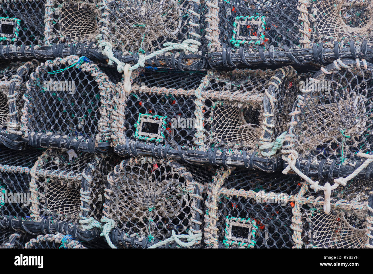 Creels for trapping shellfish stacked on an English quayside Stock ...