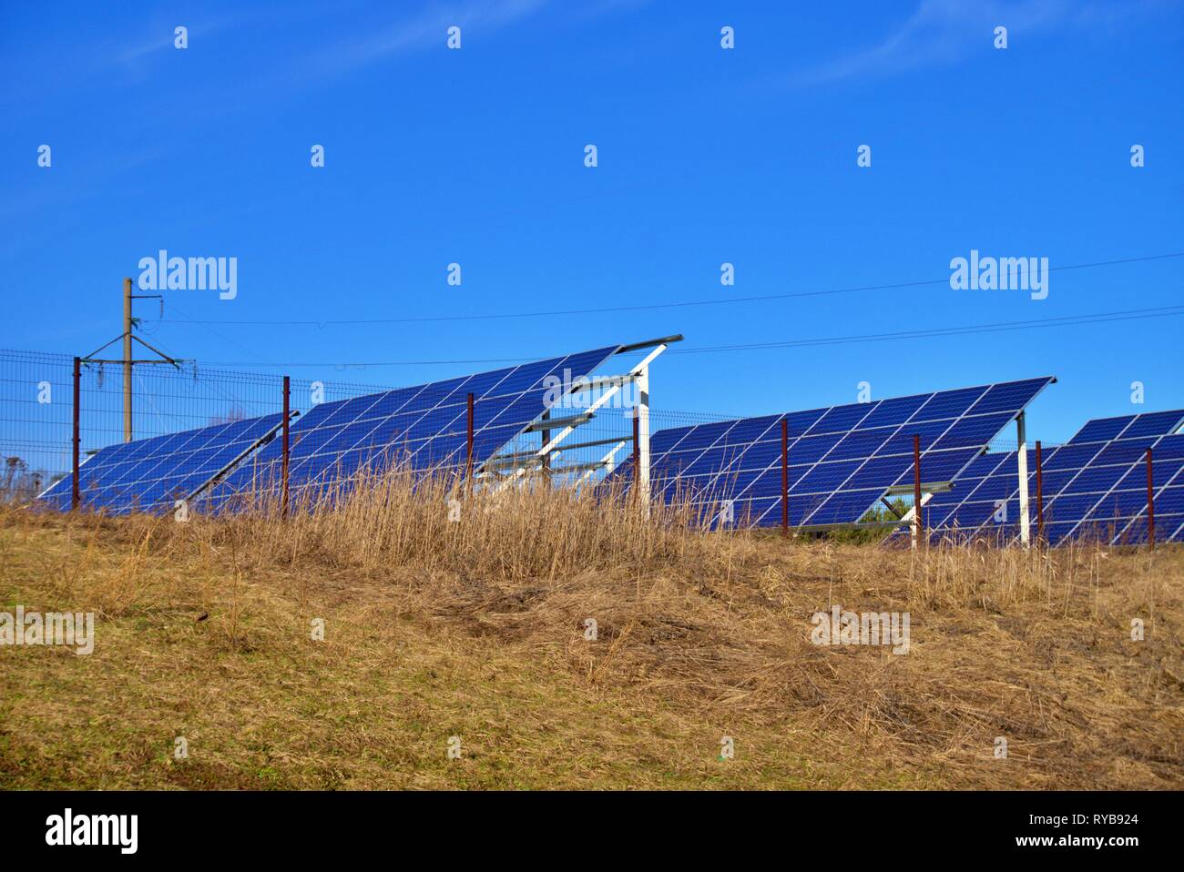 Solar Energy Farm with rows of large photovoltaic panels converting the ...