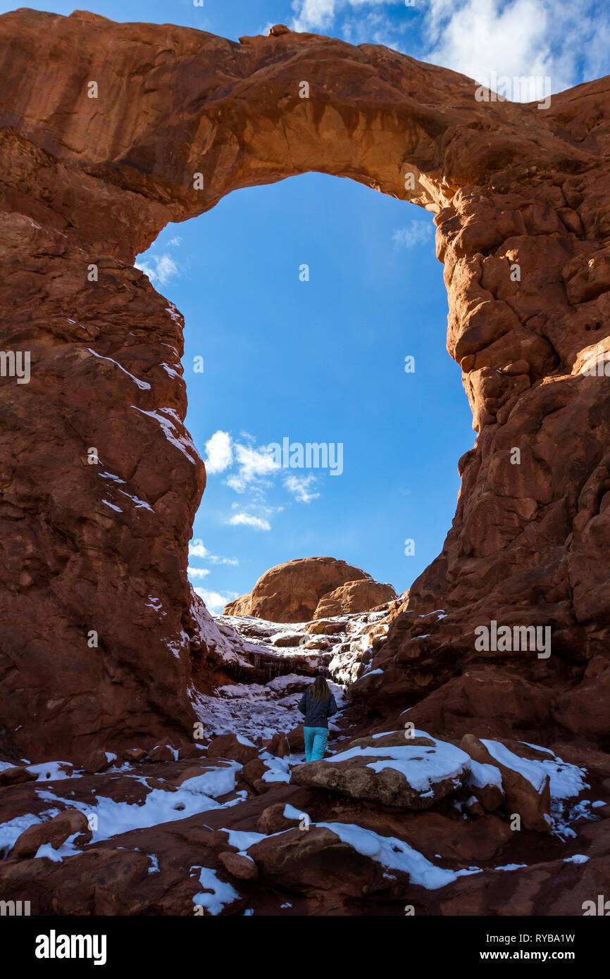 Photographer taking pictures of Turret arch early winter with snow and ...