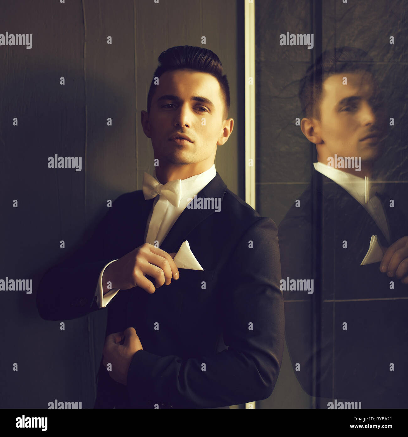 Man in suit touches handkerchief Stock Photo - Alamy