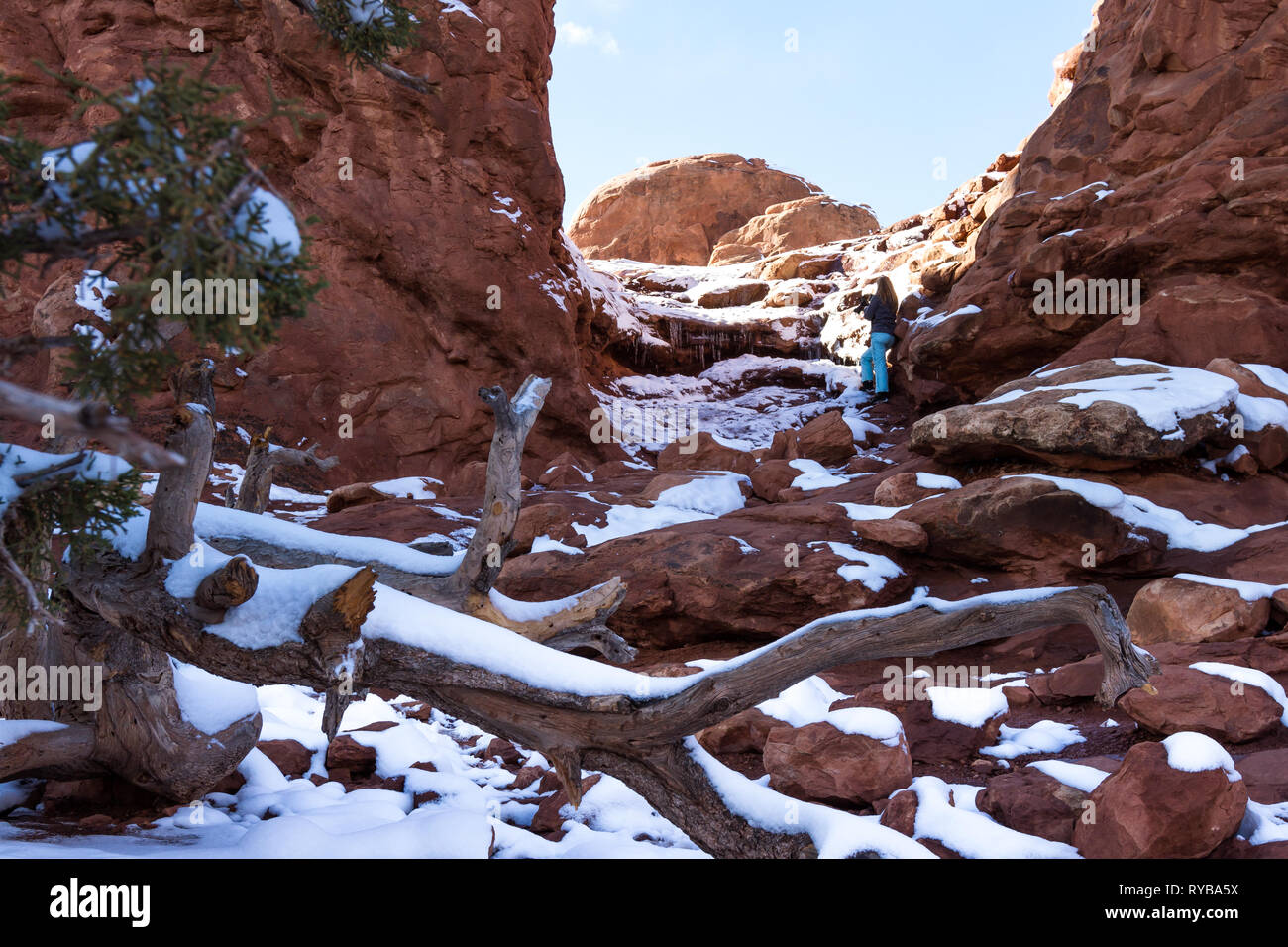 Photographer taking pictures of Turret arch early winter with snow and ...