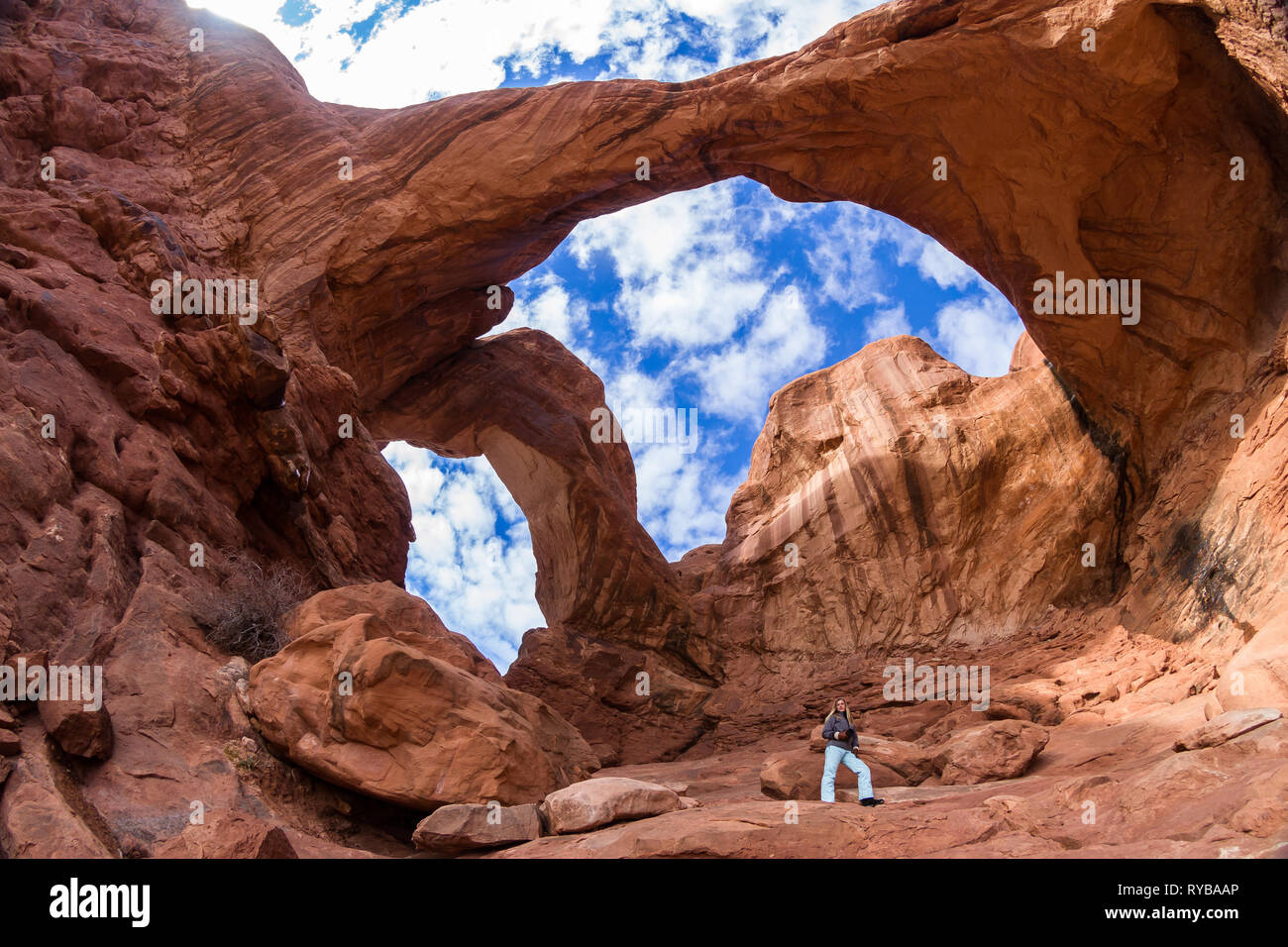 Woman standing at the base of Double Arch to give size perspective of ...