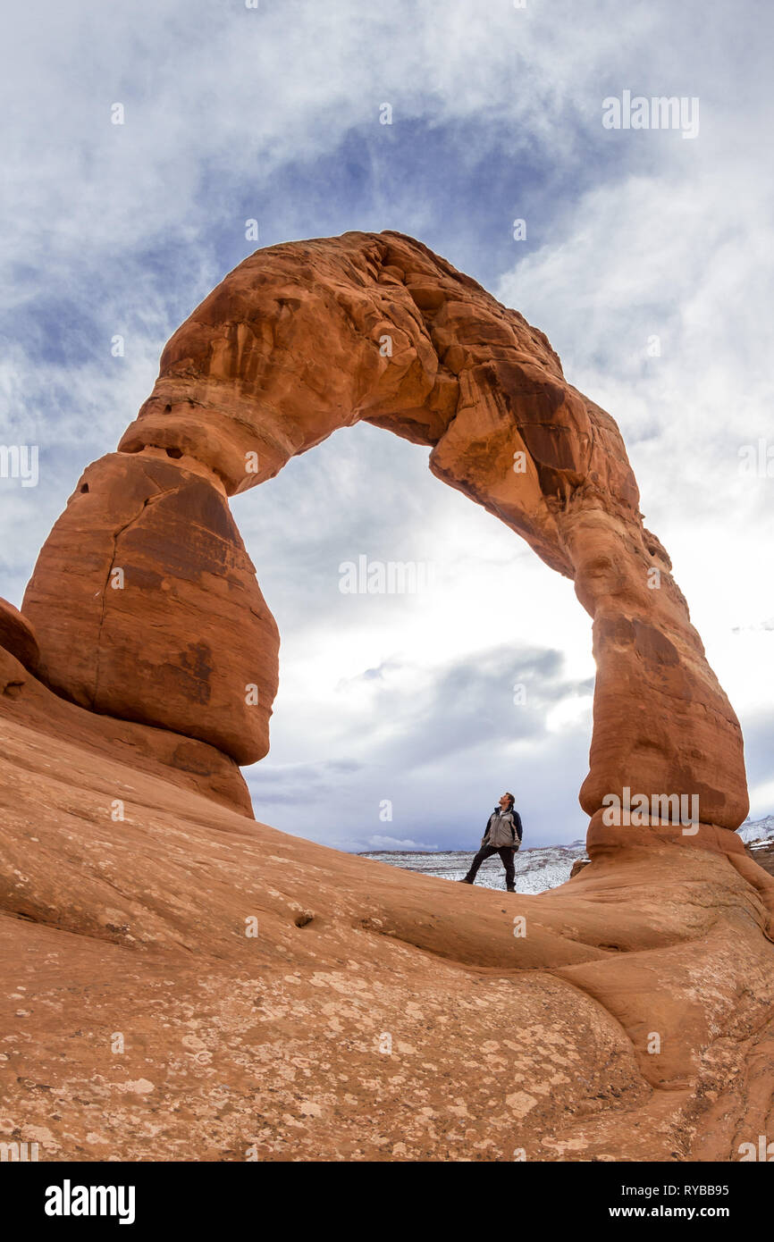 Man standing at the base of Delicate Arch giving a better size ...