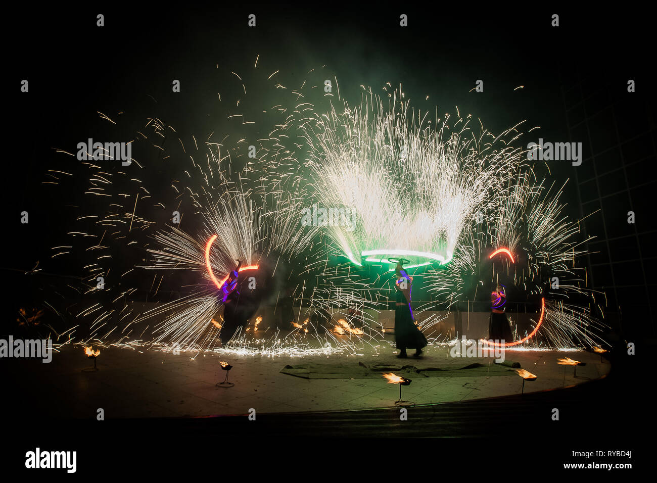 Amazing fire show dance. Fire dancers in beautiful costumes playing ...