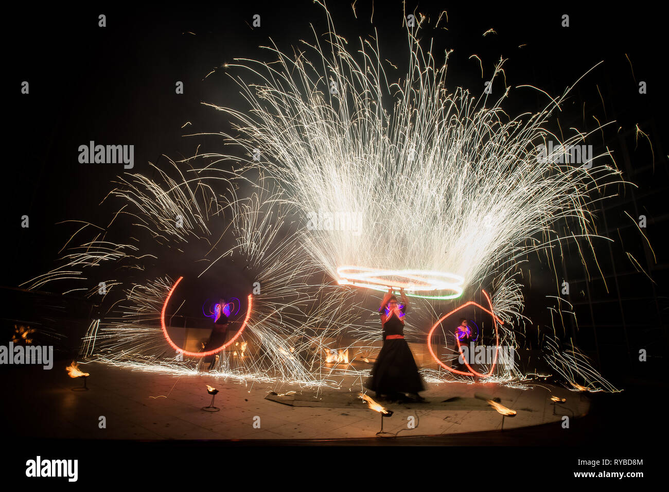 Amazing fire show dance. Fire dancers in beautiful costumes playing ...