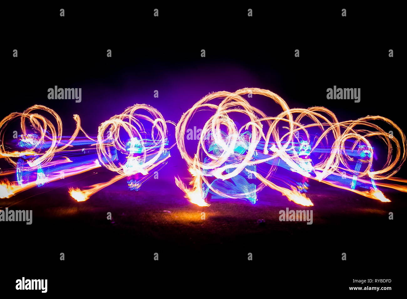 Amazing fire show dance. Fire dancers in beautiful costumes playing ...