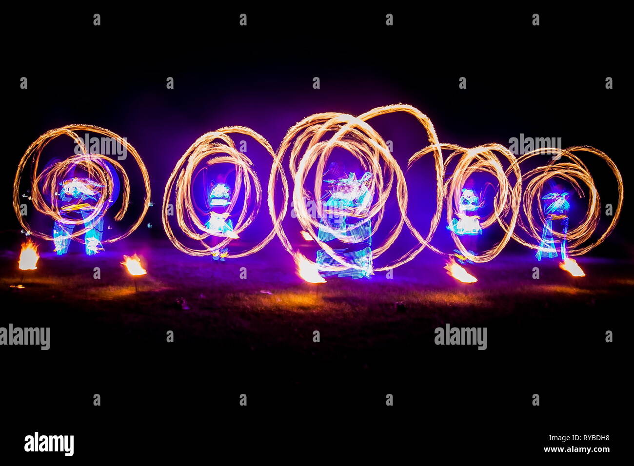 Amazing fire show dance. Fire dancers in beautiful costumes playing ...