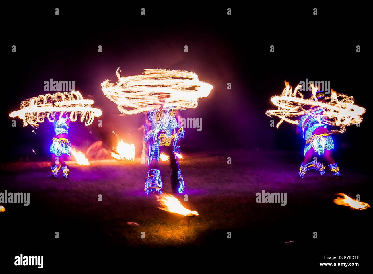 Amazing fire show dance. Fire dancers in beautiful costumes playing ...