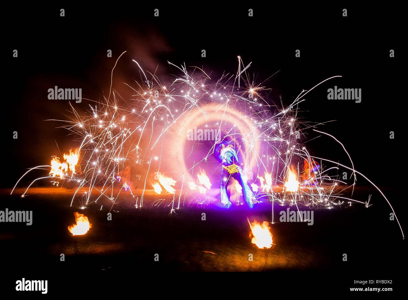 Amazing fire show dance. Fire dancers in beautiful costumes playing ...