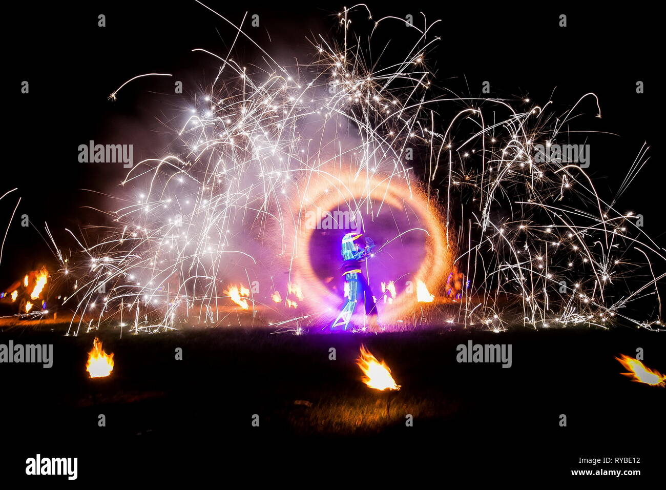 Amazing fire show dance. Fire dancers in beautiful costumes playing ...