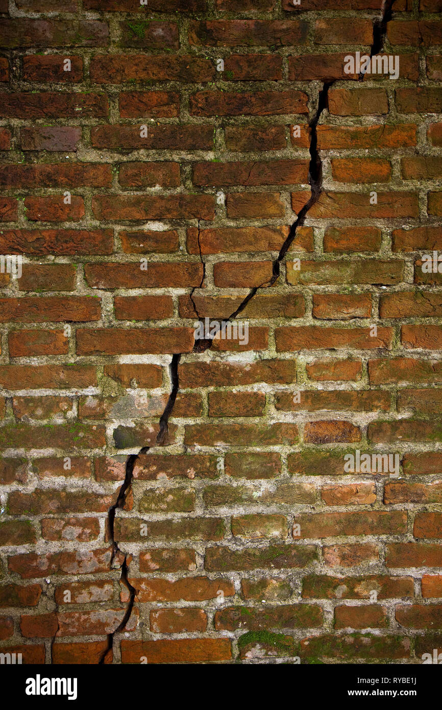 Old brick wall cracked and damaged - wall with diagonal crack Stock ...