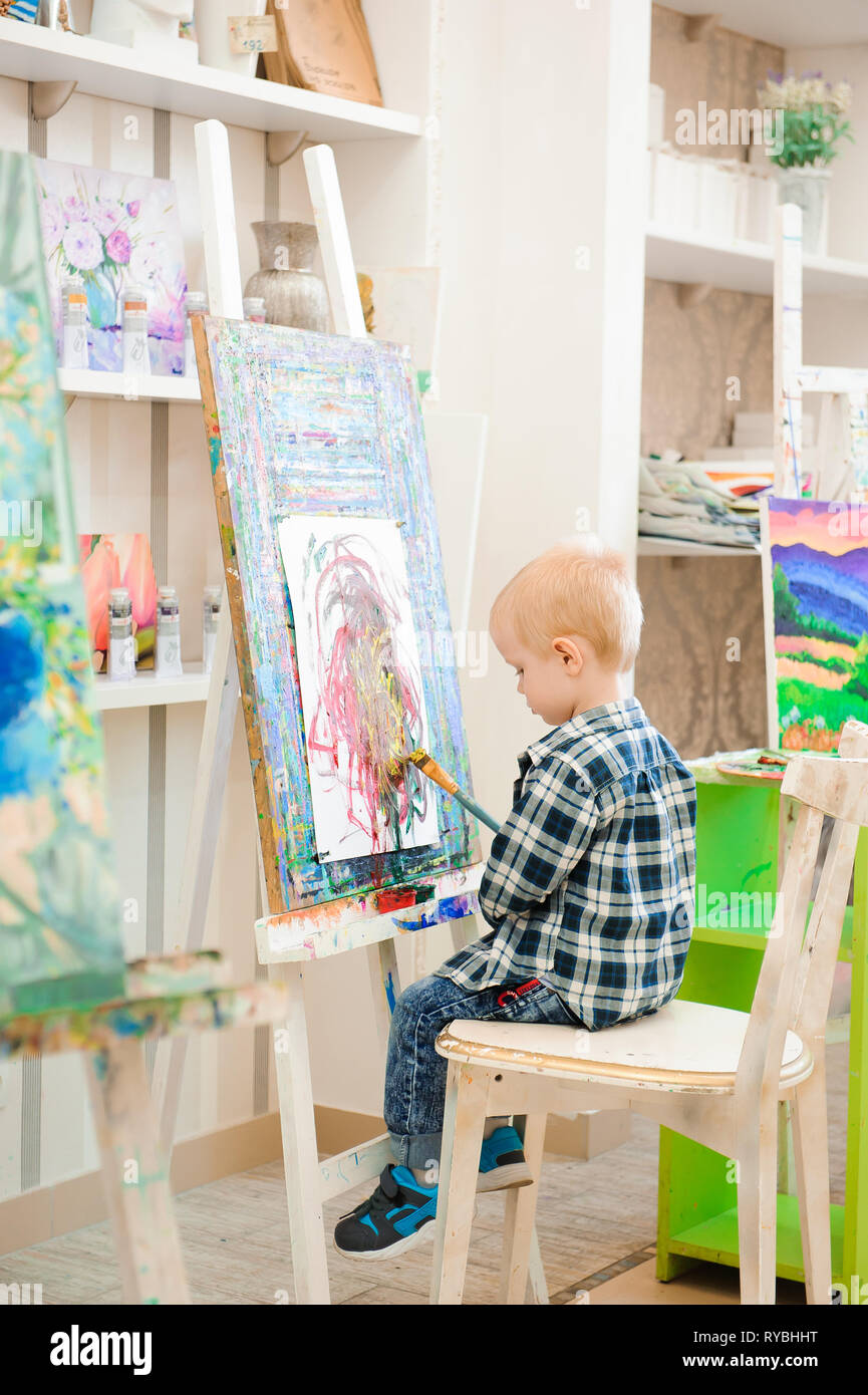 A child draws a picture paints on art lesson Stock Photo - Alamy