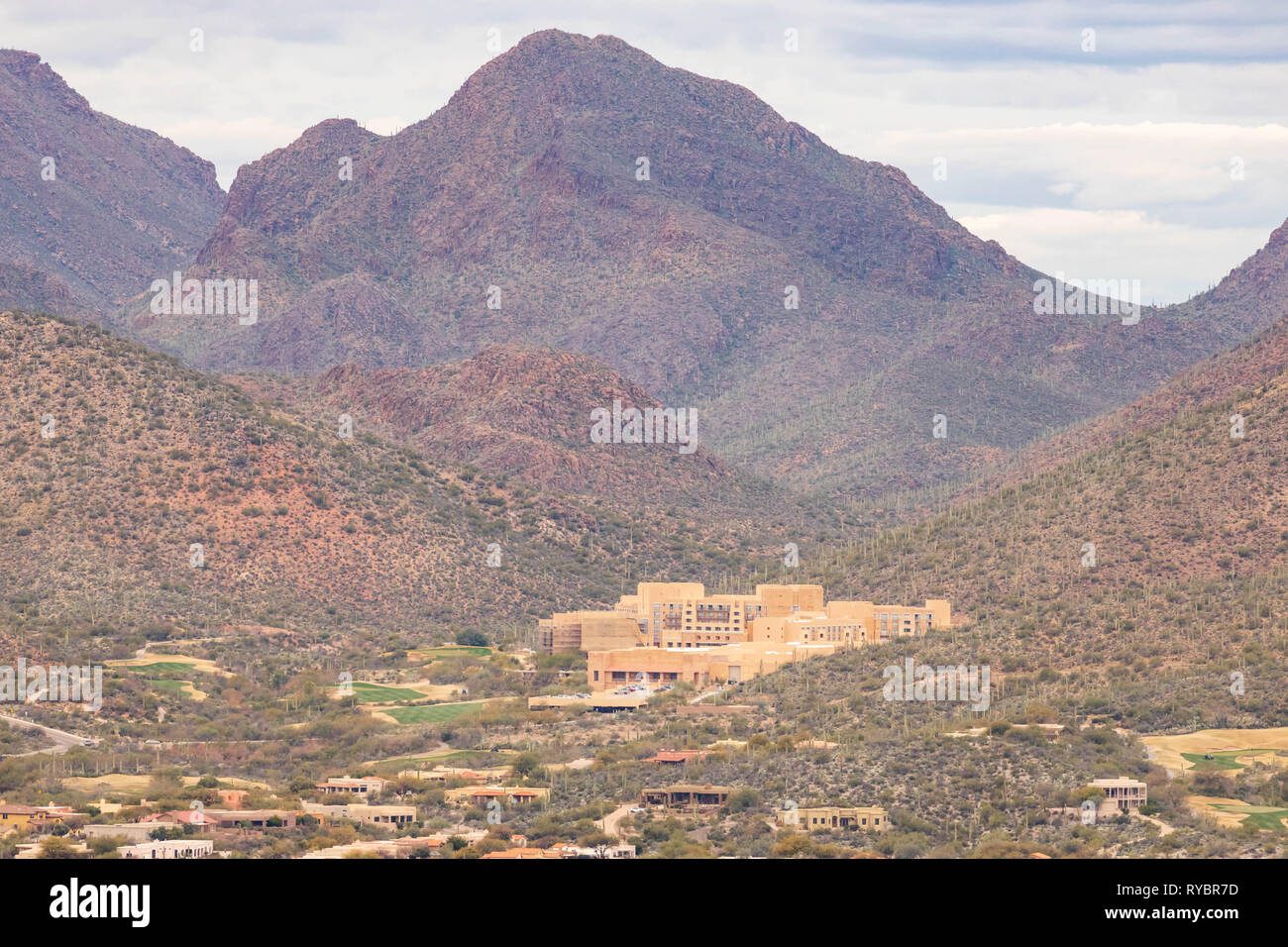 Large building complex at the base of dramatic mountains in desert ...