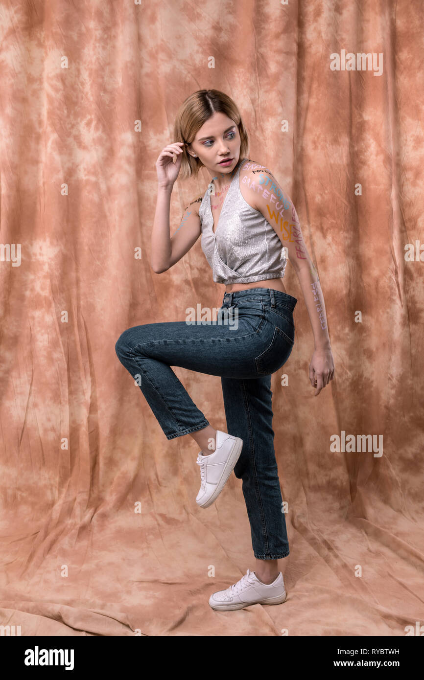 Attractive good looking woman holding one leg up Stock Photo - Alamy