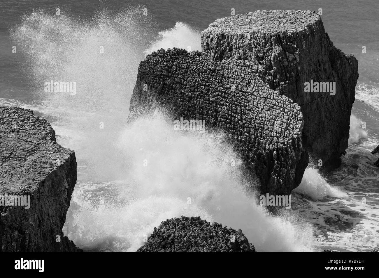 Large sharp rocks with lots of detail and texture as waves splash ...