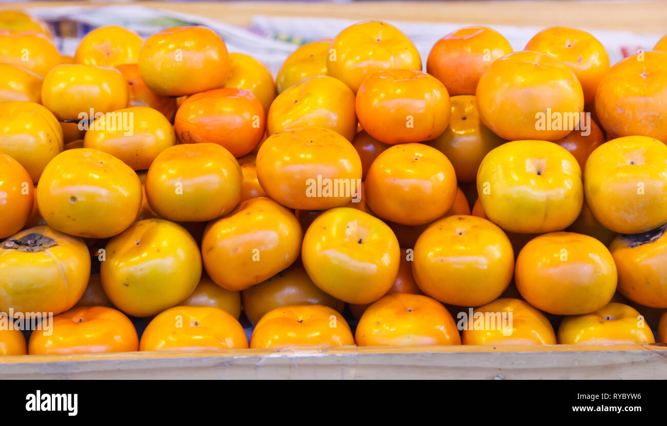 Asian or Japanese Persimmon (Persimon) fruits are sweet flavored with ...