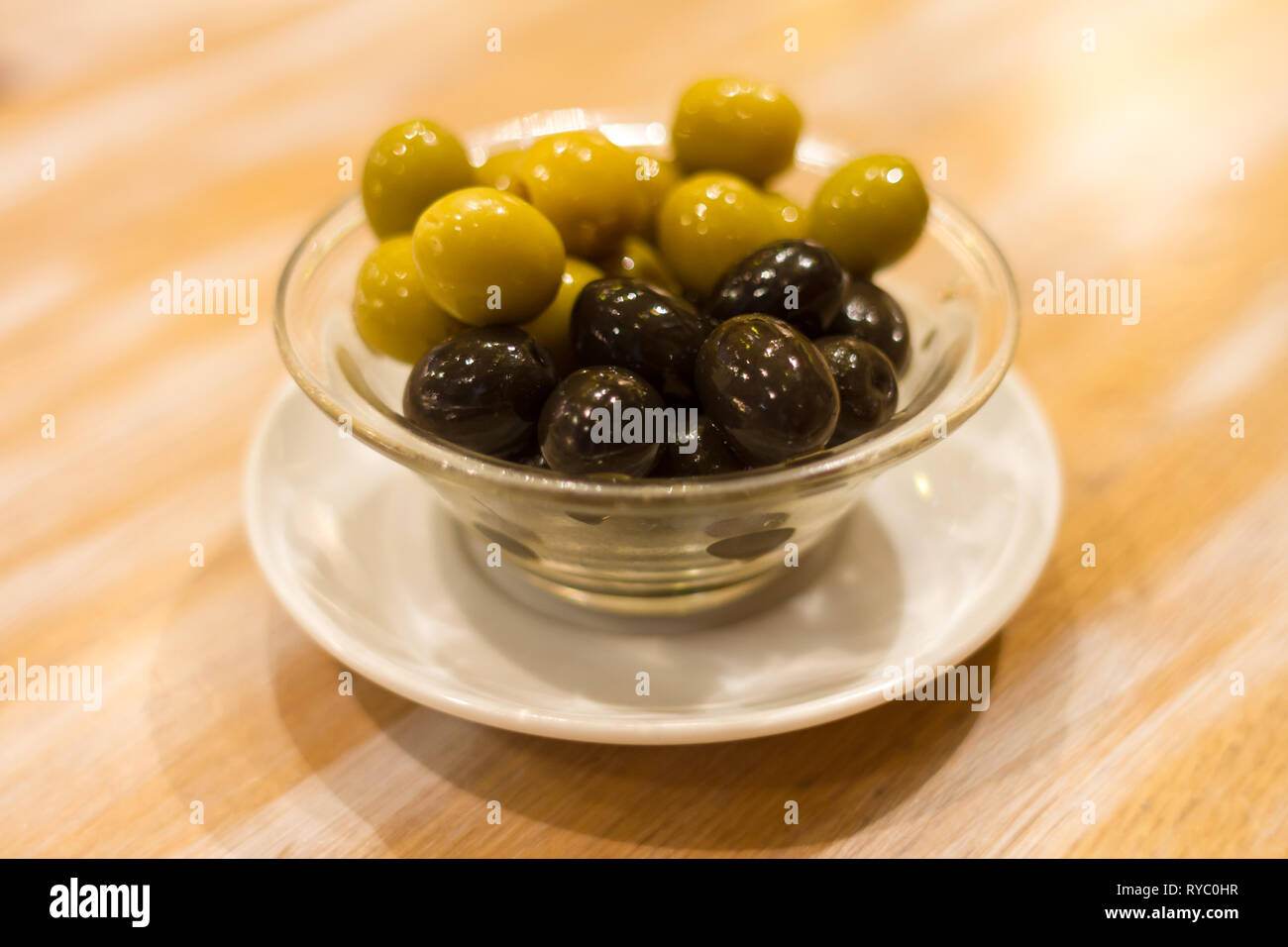 Green and black olives in a cup on a table in Barcelona, Spain Stock ...