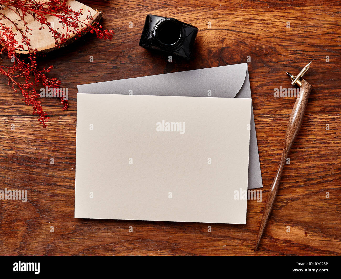 Mock up of blank envelopes on wooden background with calligraphy pen ...